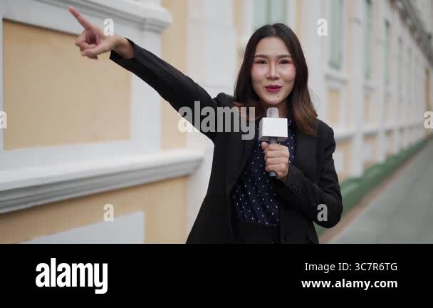 asian female reporter speaking confidently on street, holding ...