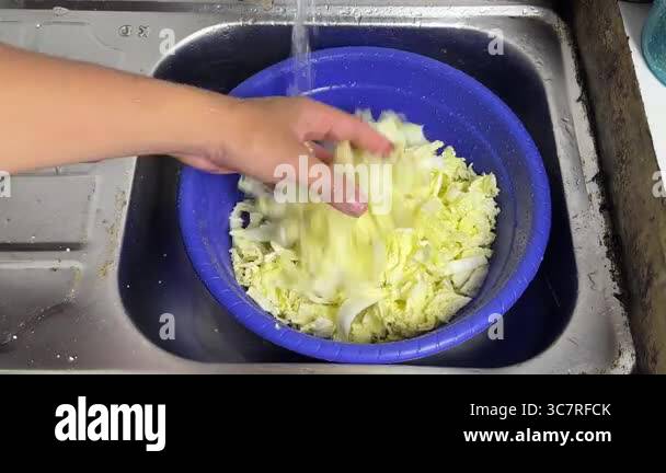 washing the cabbage and carrots in the sink Stock Video Footage - Alamy