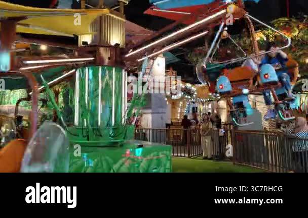 Children and their parents are having fun and excited riding a flying ...