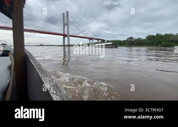 This serene video shows a boat gliding along a river under a majestic ...