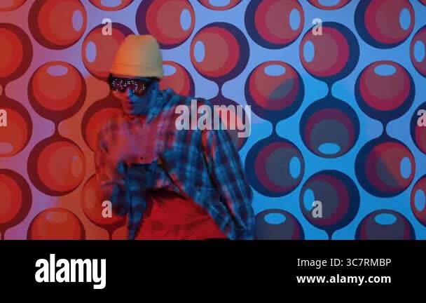 Professional break dancer wearing fancy glasses with balloon background ...