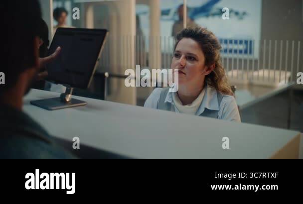 Airport Check-in Counter: Female Airline Agent Checking Traveler ...