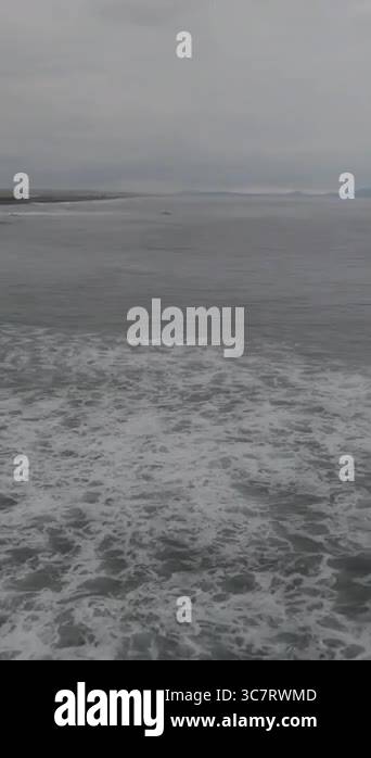 Ocean waves in cloudy weather. Footage. Sea surface along the coastline ...