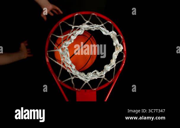 Super slow motion of basketball ball hitting the basket , Down shot ...