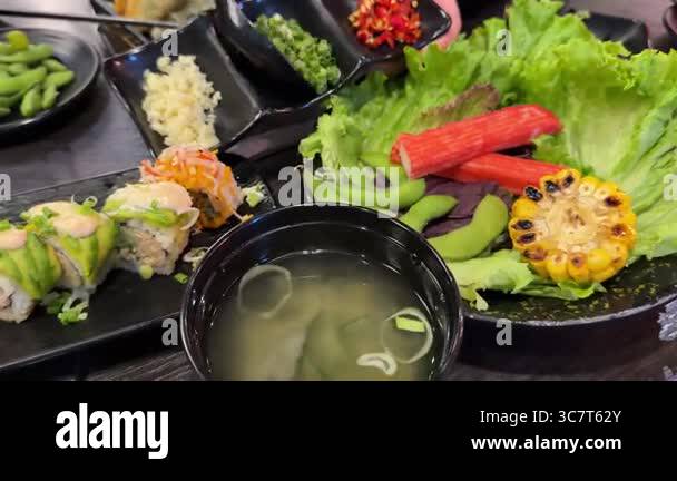sprinkle with green onions greens miso soup on the table in a black ...