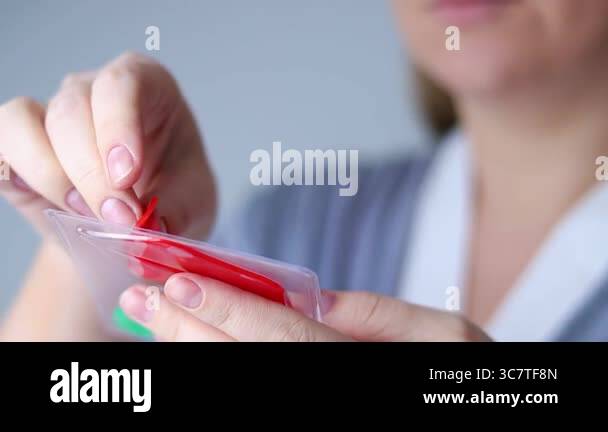 Close up of caucasian woman using a red collagen gel lip mask for dry ...