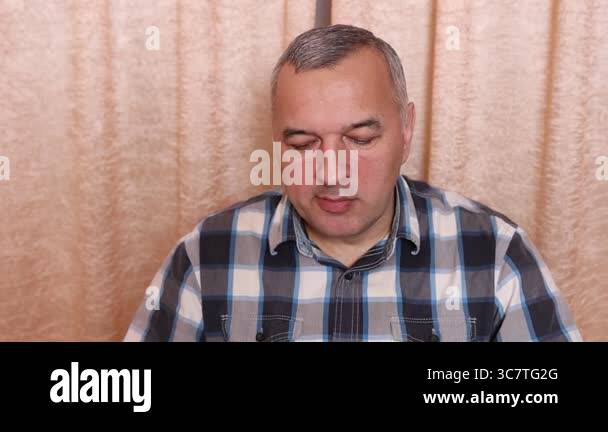 Man eating food and drinks while sitting at the table. Home cooking ...