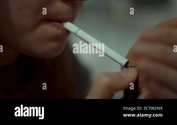 A closeup shot artistically capturing a hand smoking a cigarette ...