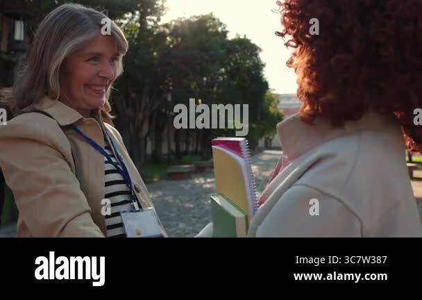 Two happy mature women, possibly teachers or university professors ...