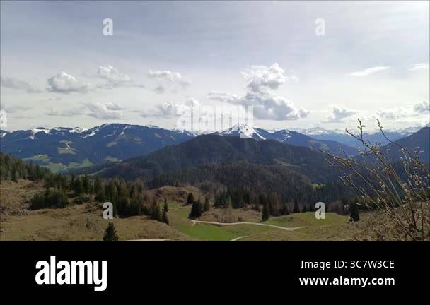 Breathtaking mountain landscape in spring with greenery and snow-capped ...