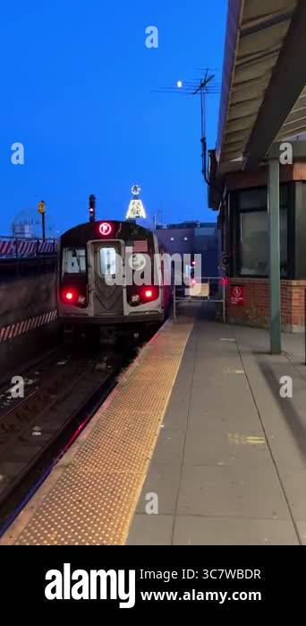 Silver train in New York leaves the station in the evening with the ...