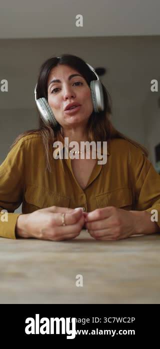 Latin woman wear headphones provide explanations, speaking with client ...