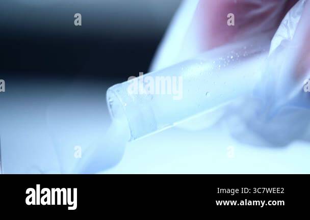 Testing sample of liquid in test tube close up 4k shot slow motion ...