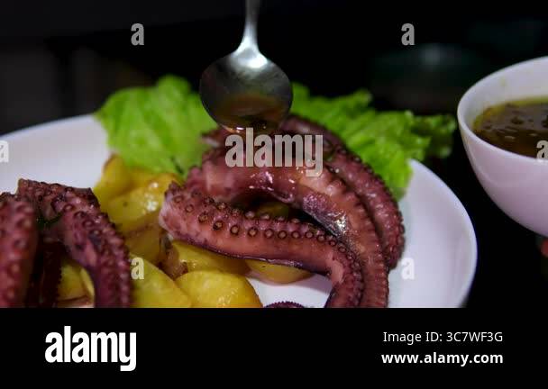 Octopus cooking, chef Boiling fresh octopus on restaurant kitchen ...