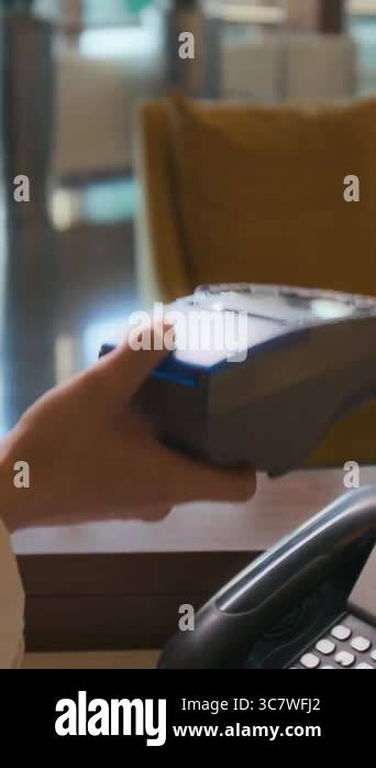 Vertical close up shot of unrecognizable man tapping credit card on ...