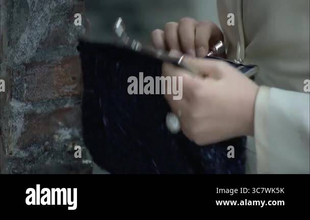 Opening a woman's handbag, taking out a small note, pulling out a brick ...