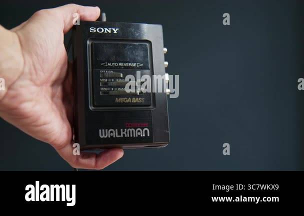 Berlin, Germany - April, 2025: Inserting an audio cassette into a ...