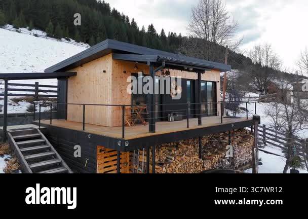 Modern wooden cabin in snowy Carpathian village with terrace and ...