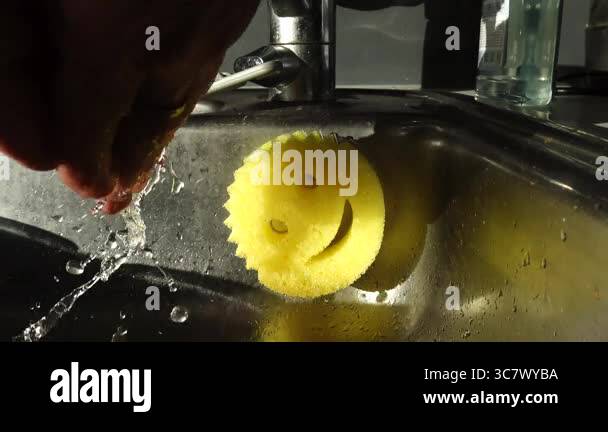 Helsinki, Finland A person turns on the faucet in a sink and smiley ...