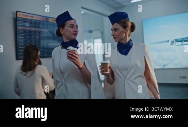 Crowded International Airport Terminal: Two Beautiful Flight Attendants ...