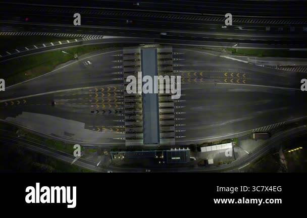 Night aerial video view of a toll booth with multiple toll lanes and ...