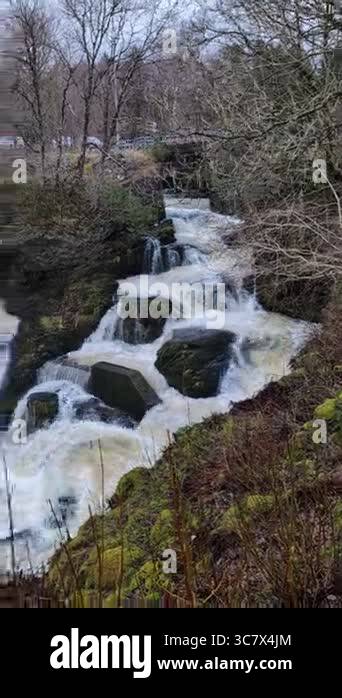 scenic view of waterfall steam moving down the rocks in the forest ...