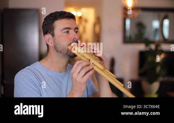 handsome Man playing a wooden pan flute Stock Video Footage - Alamy