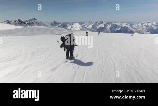 Skiing in the Alps, male skier going fast descend, dynamic follow shot ...
