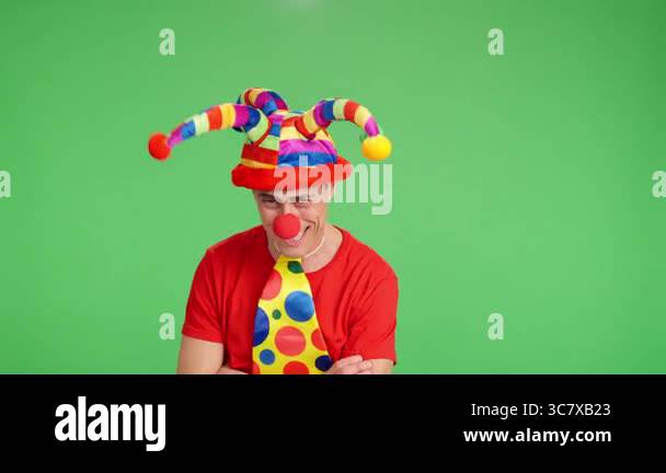 Funny clown pointing aside, isolated on a green screen background Stock ...