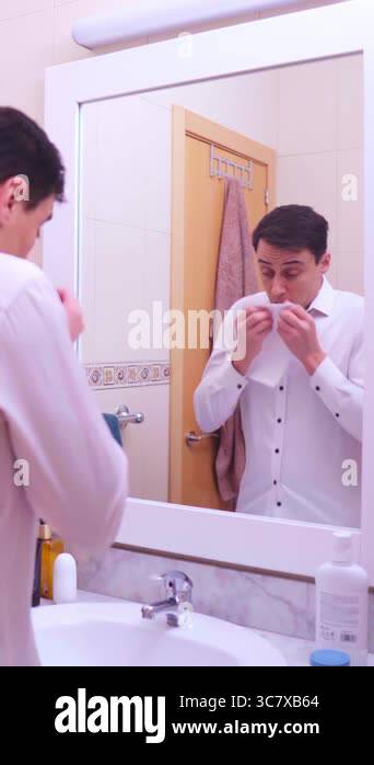 Sick employee getting ready for work in bathroom mirror Stock Video ...