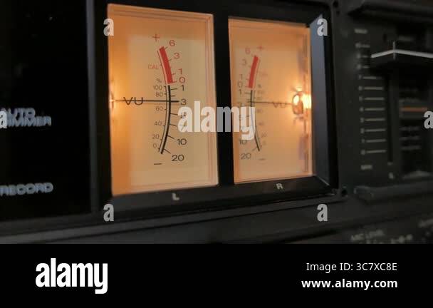Close up of sound meters on a analogue tape machin. the camera rotates ...