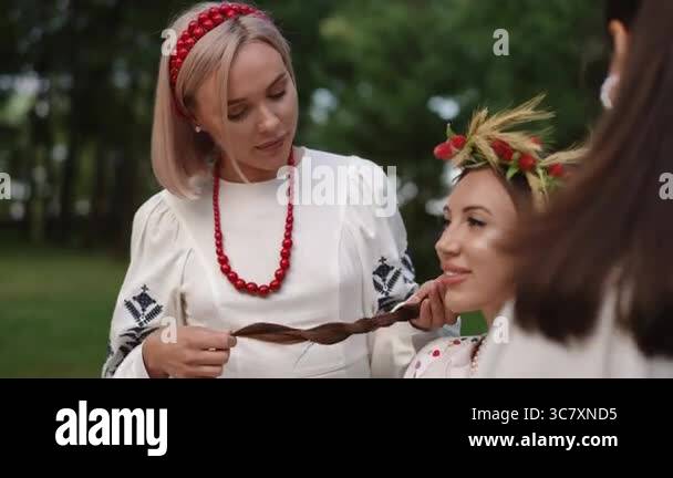 Women joyfully engage in cultural hair styling with beautiful natural ...