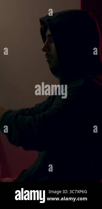 An unknown hacker in front of monitors and breaking secret data and ...