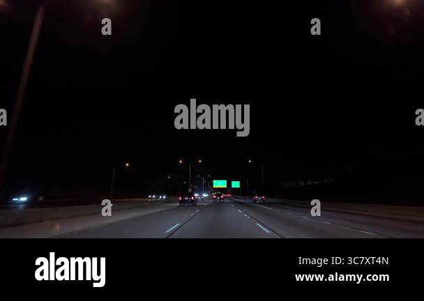 Driving in on the empty night road with light. Wide POV wide shot ...