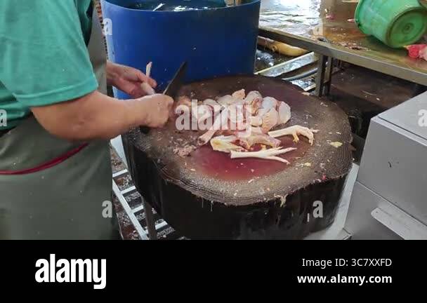 butcher chopping chicken meat into small pieces Stock Video Footage - Alamy