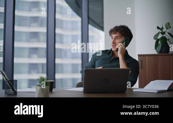 Happy director calling mobile phone sitting modern office desk closeup ...