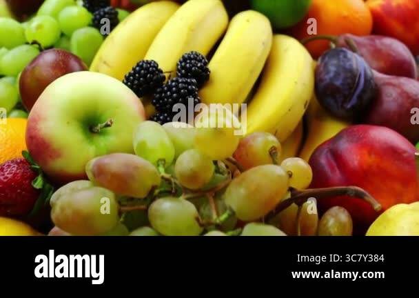 Close-up shot of a vibrant assortment of fresh fruits, including apples ...