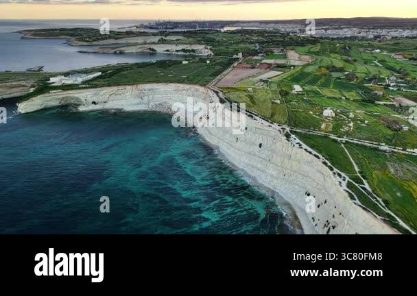 Witness the beauty of Malta as the sun rises over the tranquil waters ...
