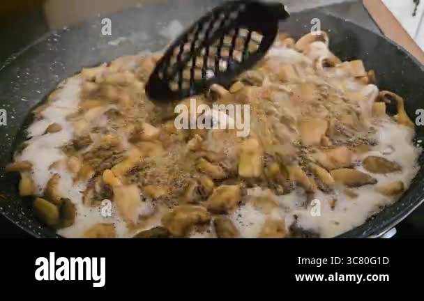 Frying and Stirring Chopped Mushrooms in Skillet Over Medium Heat in ...