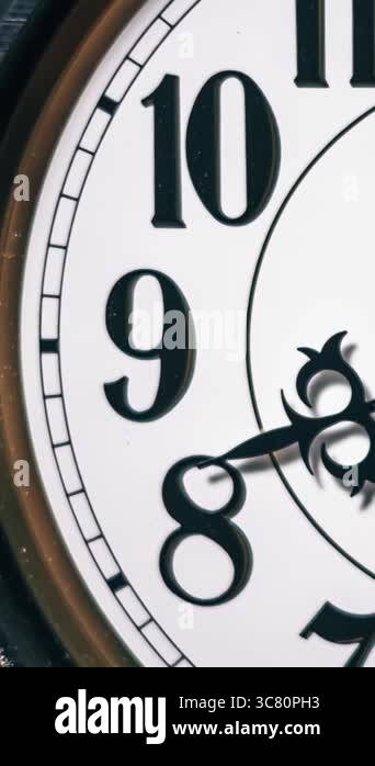 Vertical timelapse shows ornate hands spinning fast on white clock face ...