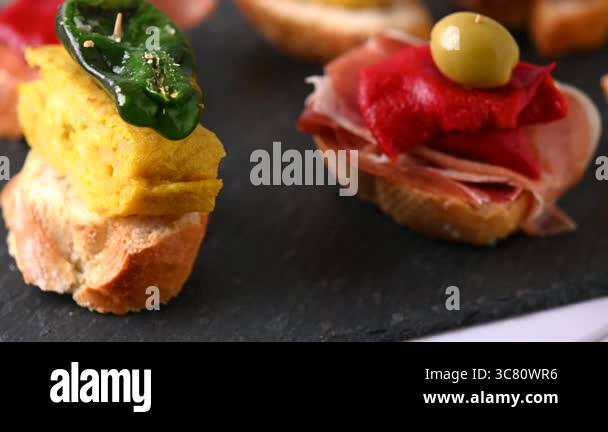 Traditional Spanish pintxos on wooden table Stock Video Footage - Alamy