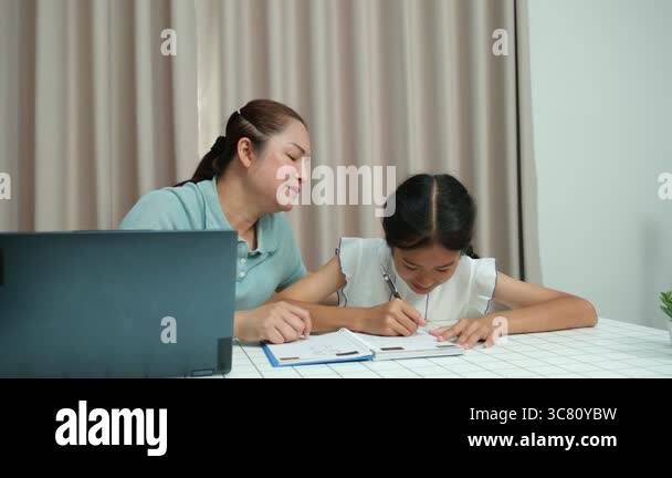 Young girl seeks help from his mother to complete homework assigned by ...