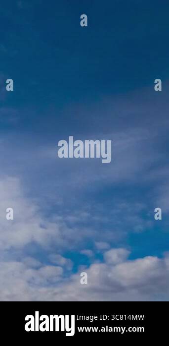 Soft light clouds quickly flowing by the horizon. Heavy grey clouds ...