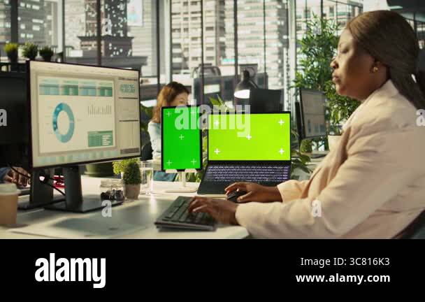 Isolated screen laptop and tablet on office desk next to employee ...
