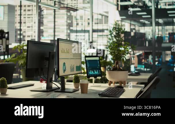 Tablet and PC on desk displaying financial graphs of company profits ...