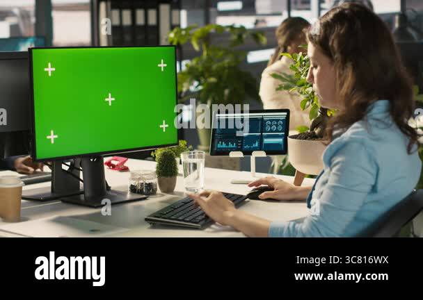 Green screen PC in office used by employee working on company ...