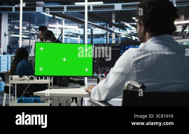 Data center engineer with paraplegia using AI deep learning algorithms on green screen PC to ...
