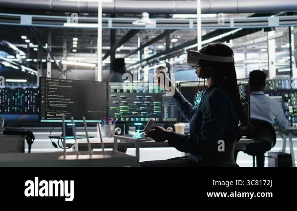 Data center technician using virtual reality tech and node tree software to analyze datasets ...