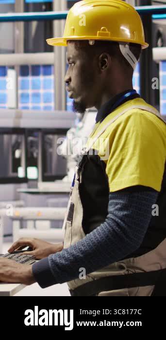 Vertical video Smart factory employee typing on PC keyboard, testing ...