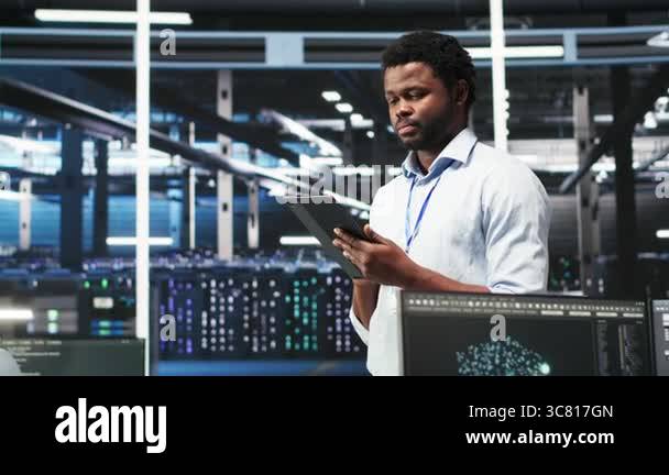 Data center technician using tablet to do node tree programming, optimizing resource allocation ...